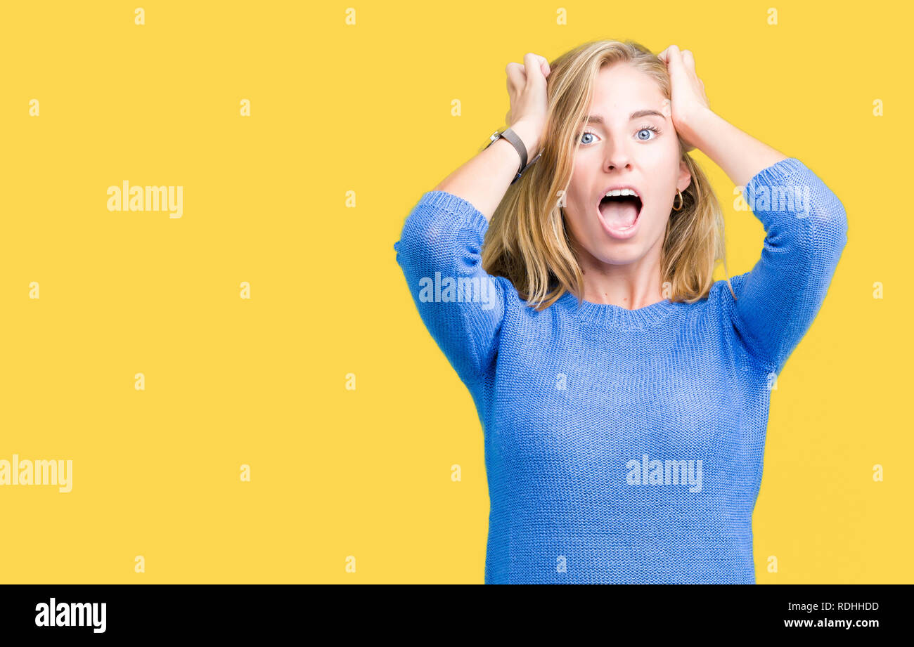 Beautiful young woman wearing blue sweater over isolated background ...