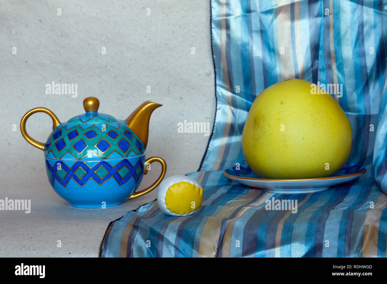 Colourful still life photograph of different objects: tea pot, plate ...