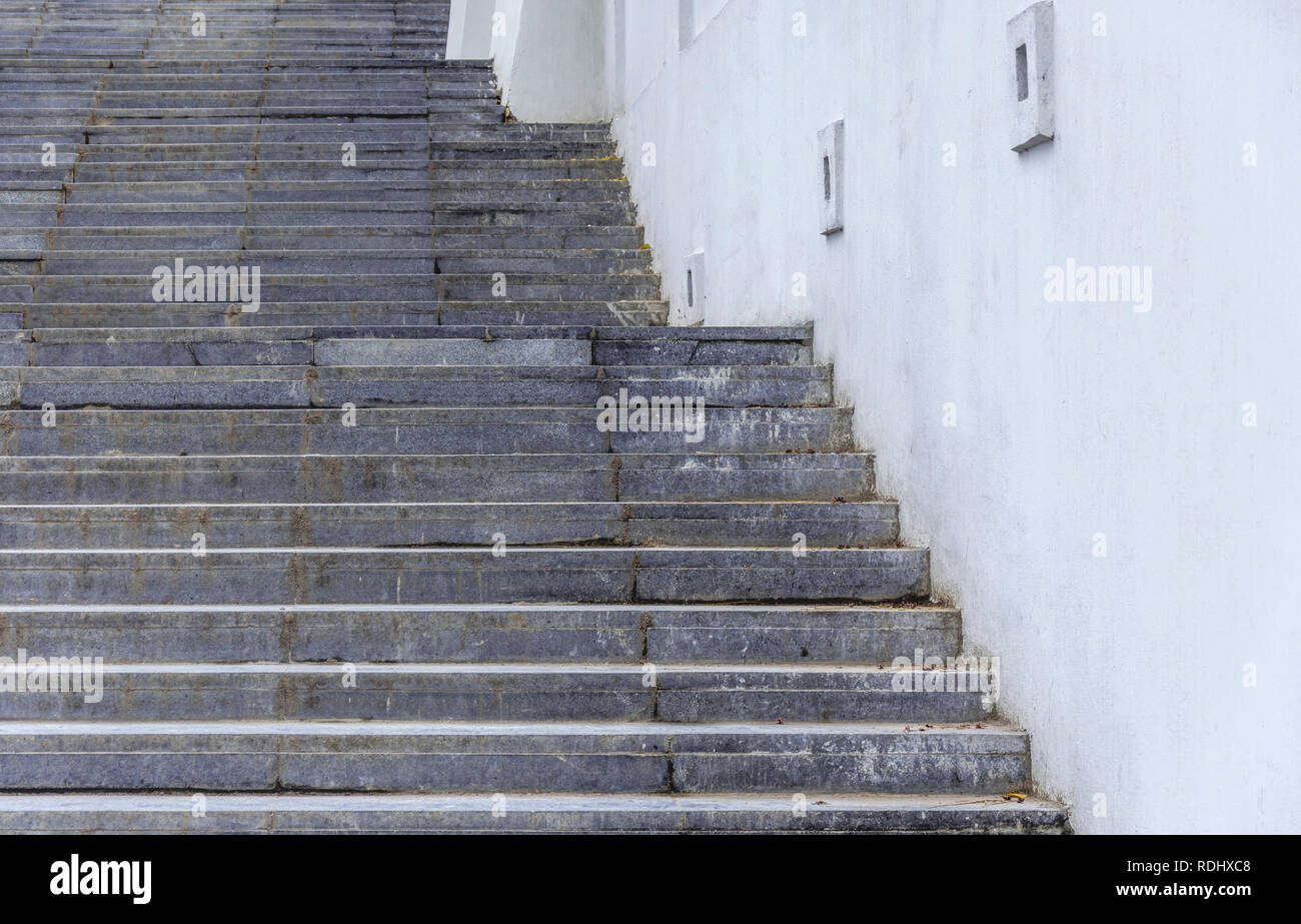 Damage and dirty stairs in the city with white house wall Stock Photo ...