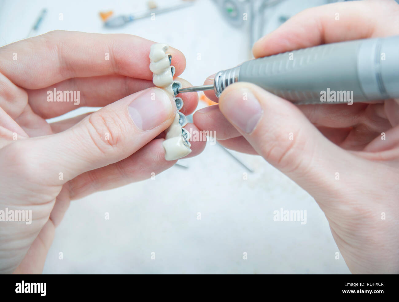 Dental technician manifacturing medical tooth prosthetic in laboratory ...