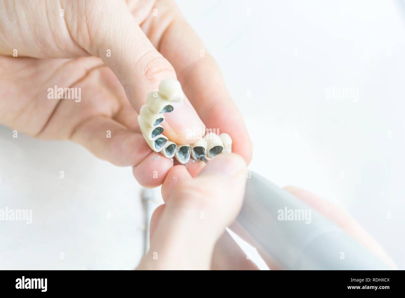 Dental technician tooth prosthetic makeing in laboratory Stock Photo ...