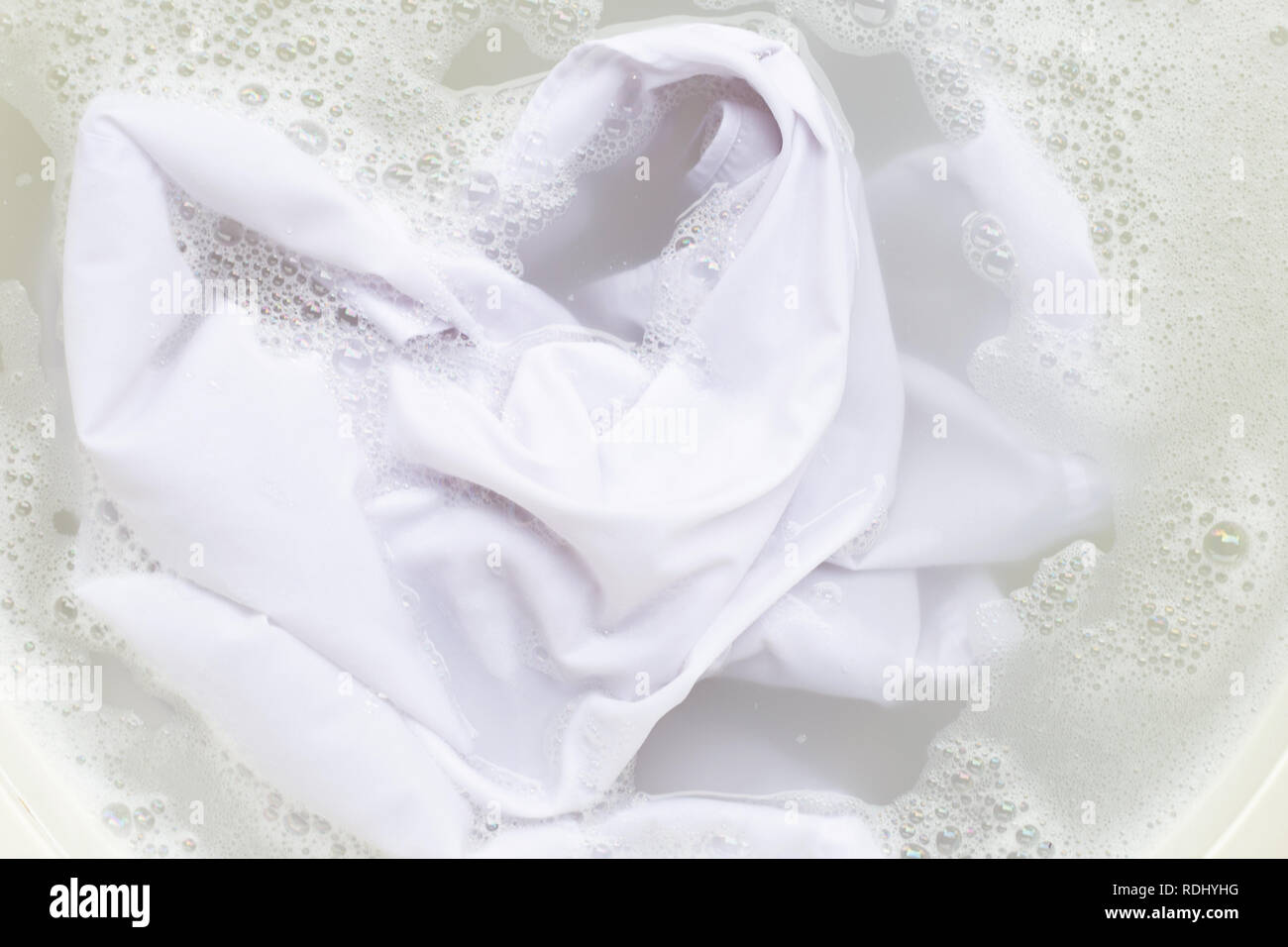 Soak a cloth before washing, white shirt Stock Photo - Alamy