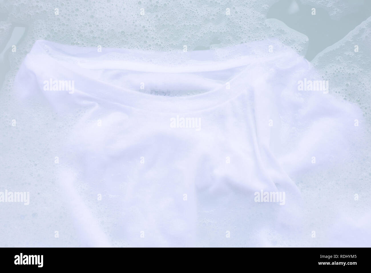 Soak a cloth before washing, white T-shirt Stock Photo - Alamy