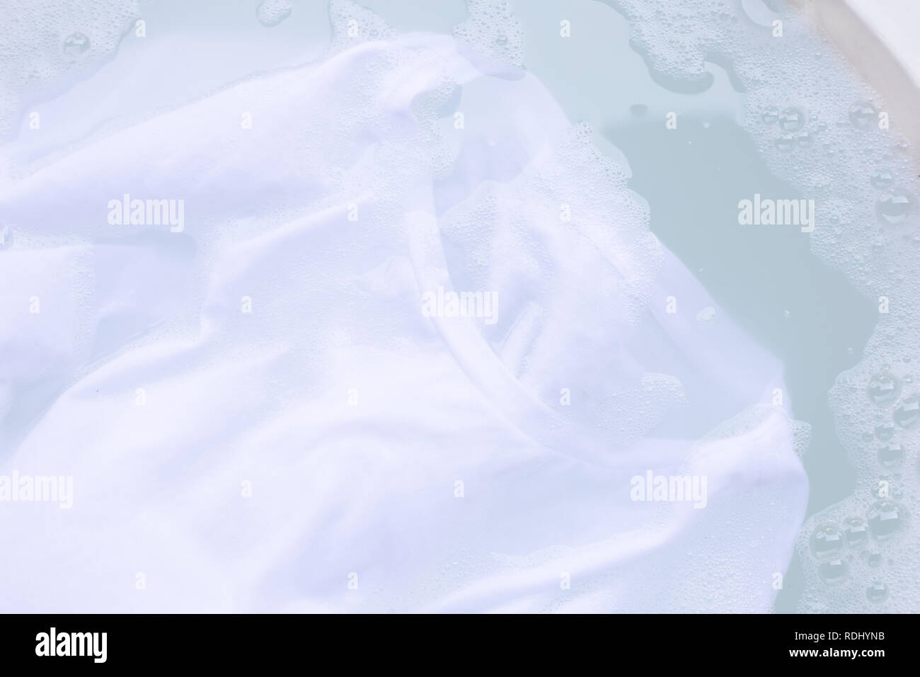 Soak a cloth before washing, white T-shirt Stock Photo - Alamy