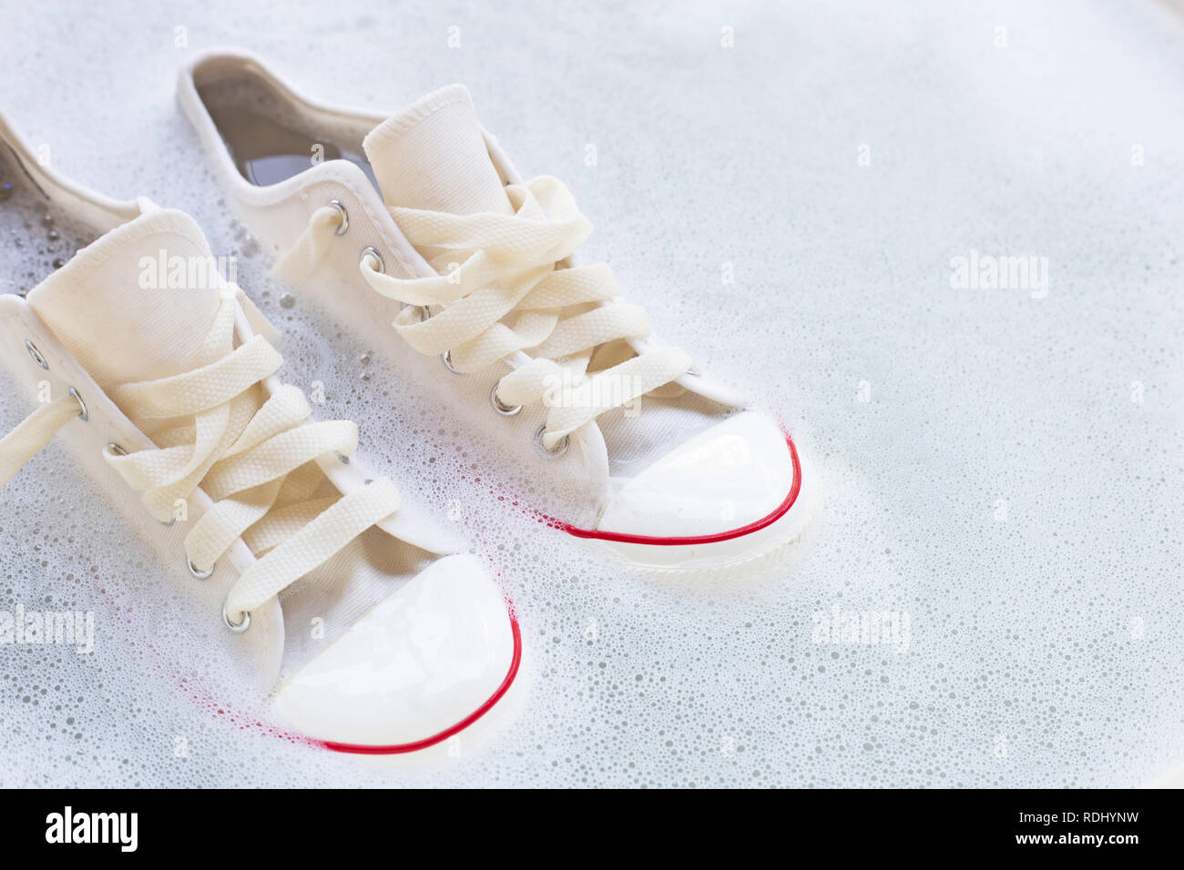 Soak shoes before washing. Cleaning Dirty sneakers Stock Photo - Alamy