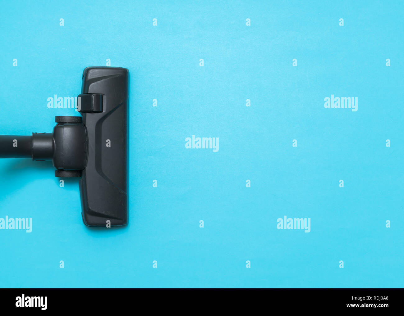 Dark head of a modern vacuum cleaner being used while vacuuming the ...