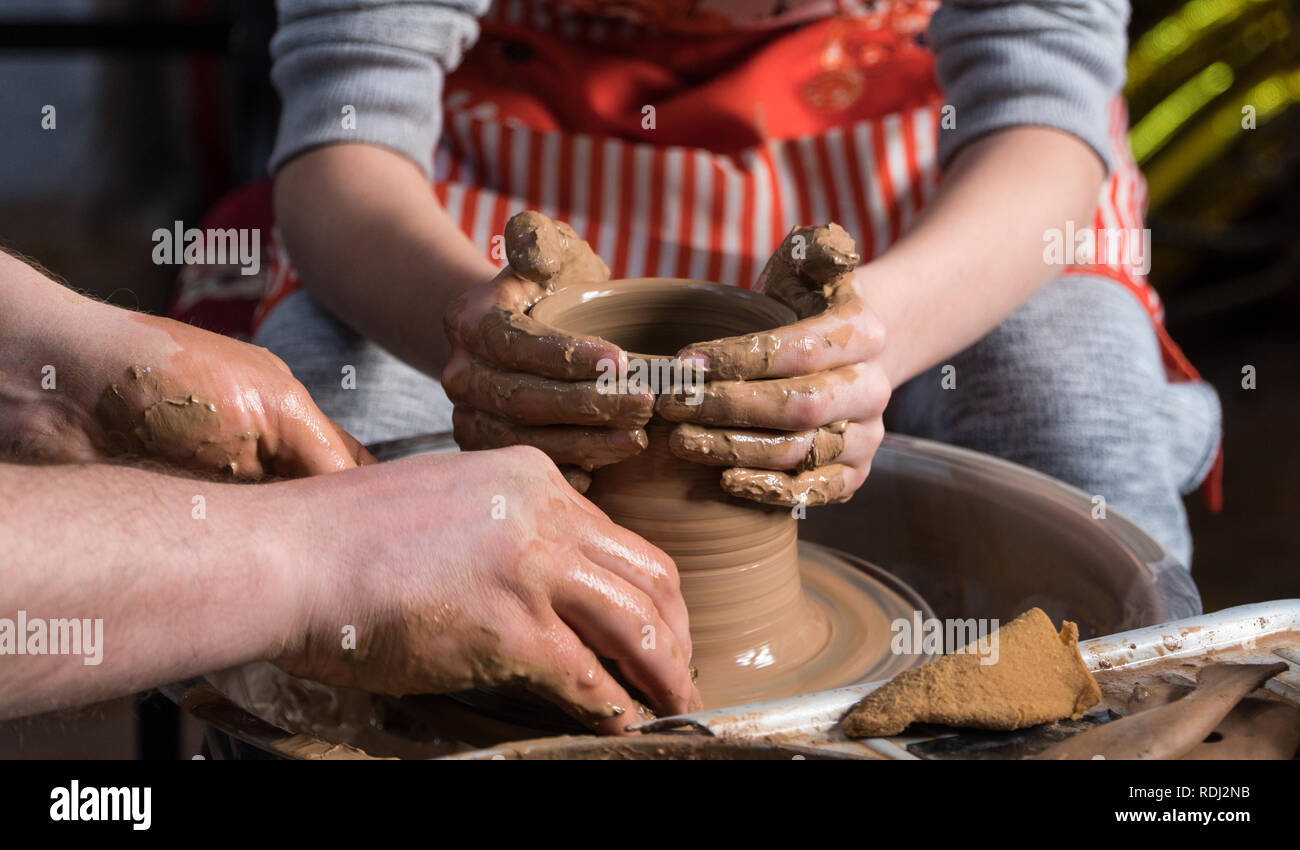 Teaching pottery to children. The teacher gives a master class in ...