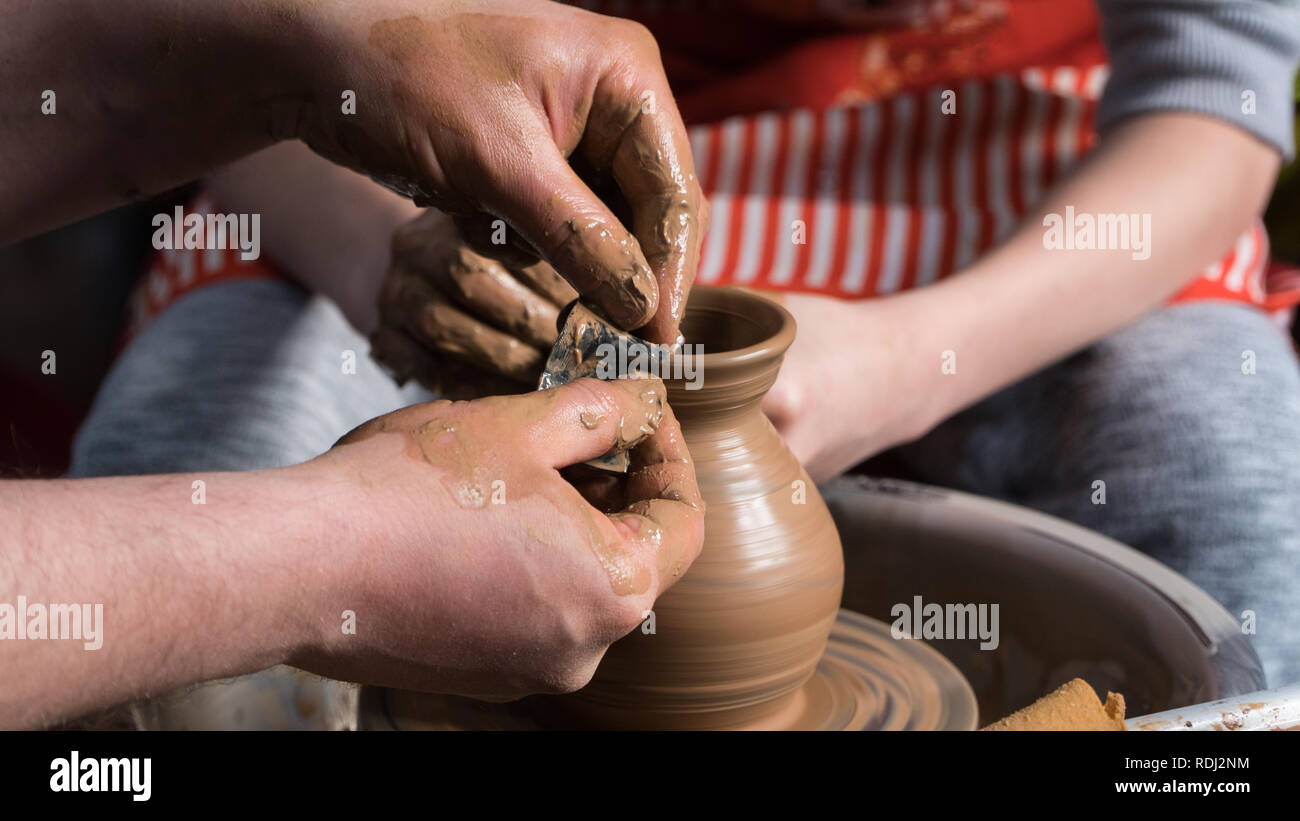 Teaching pottery to children. The teacher gives a master class in ...