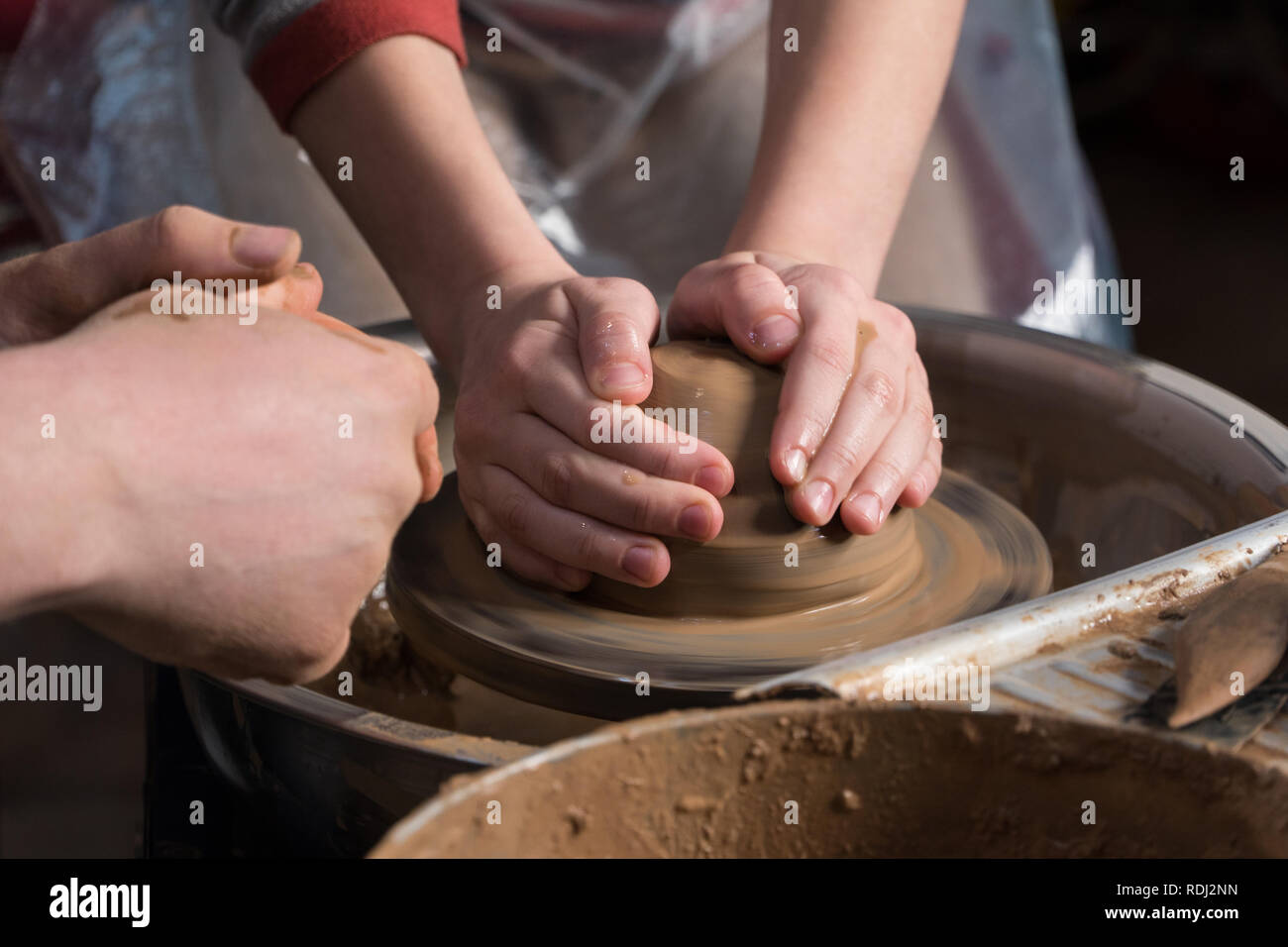 Teaching pottery to children. The teacher gives a master class in ...
