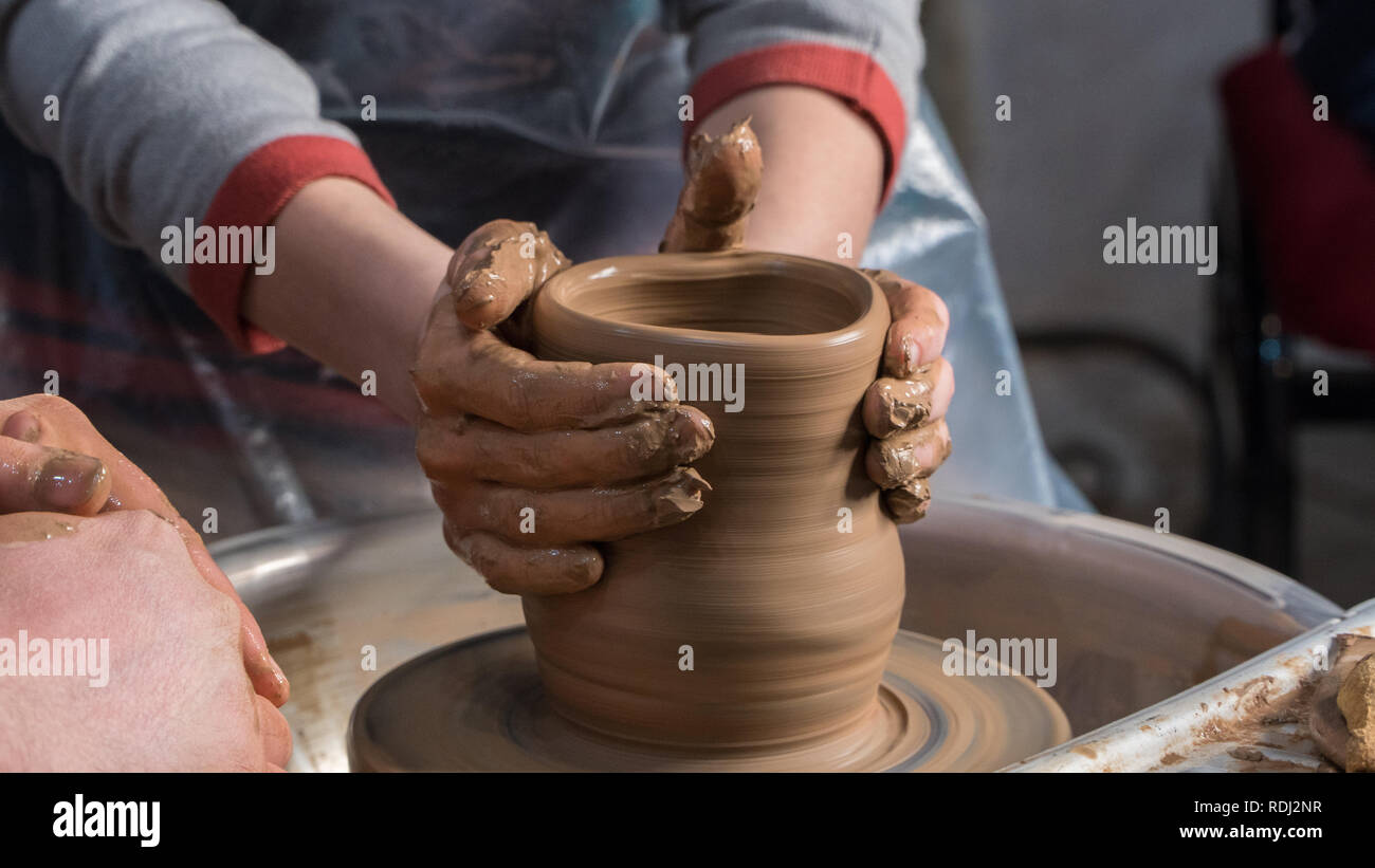 Teaching pottery to children. The teacher gives a master class in ...