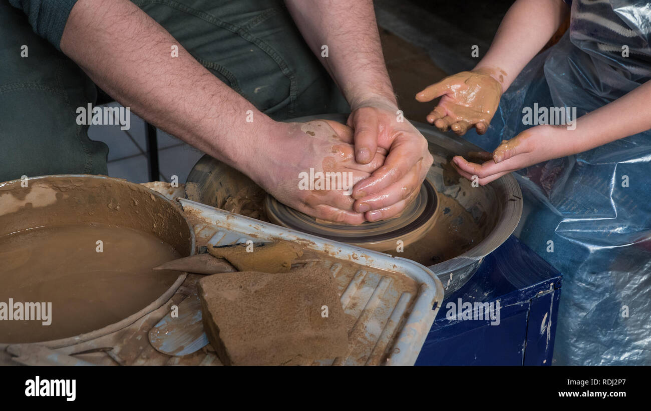 Teaching pottery to children. The teacher gives a master class in ...