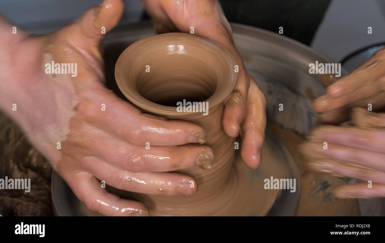 Teaching pottery to children. The teacher gives a master class in ...