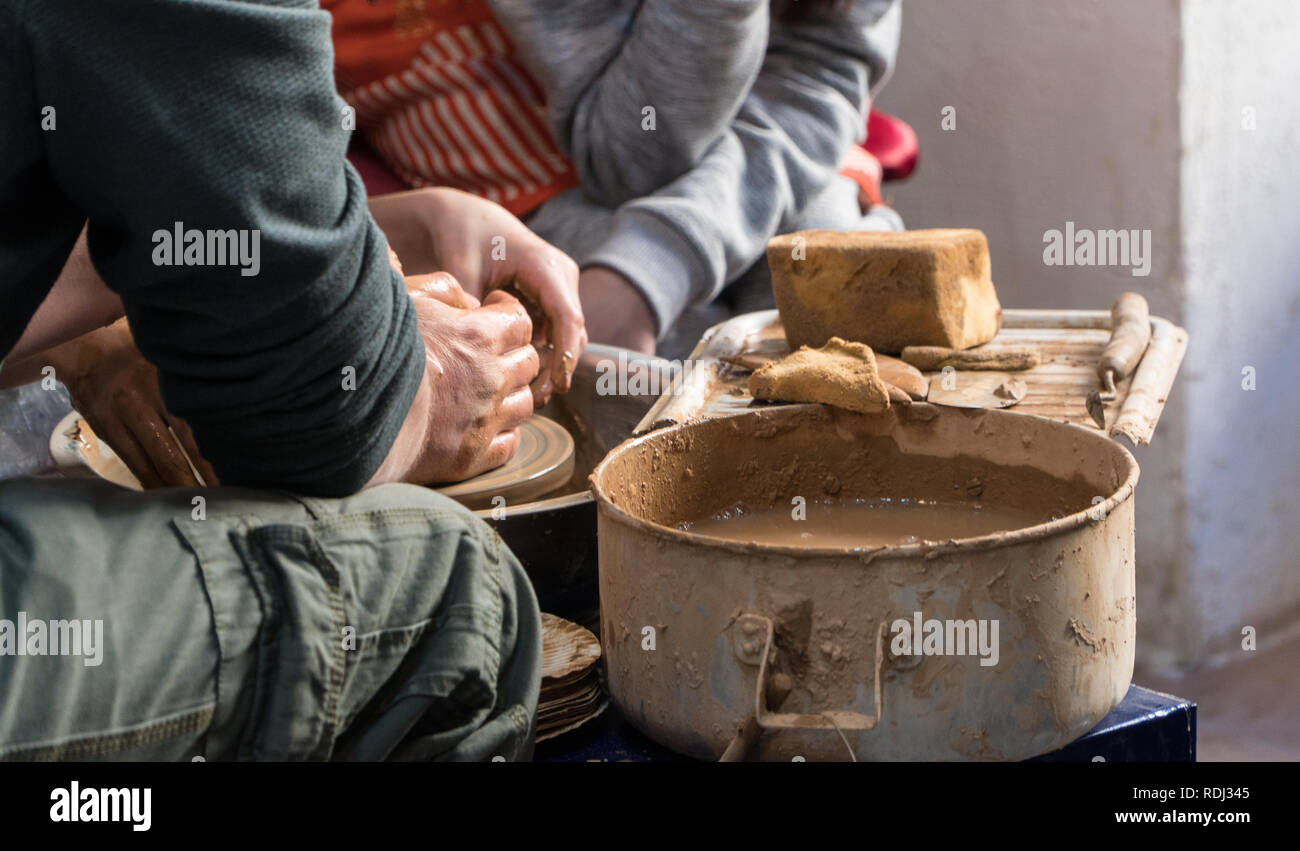 Teaching pottery to children. The teacher gives a master class in ...