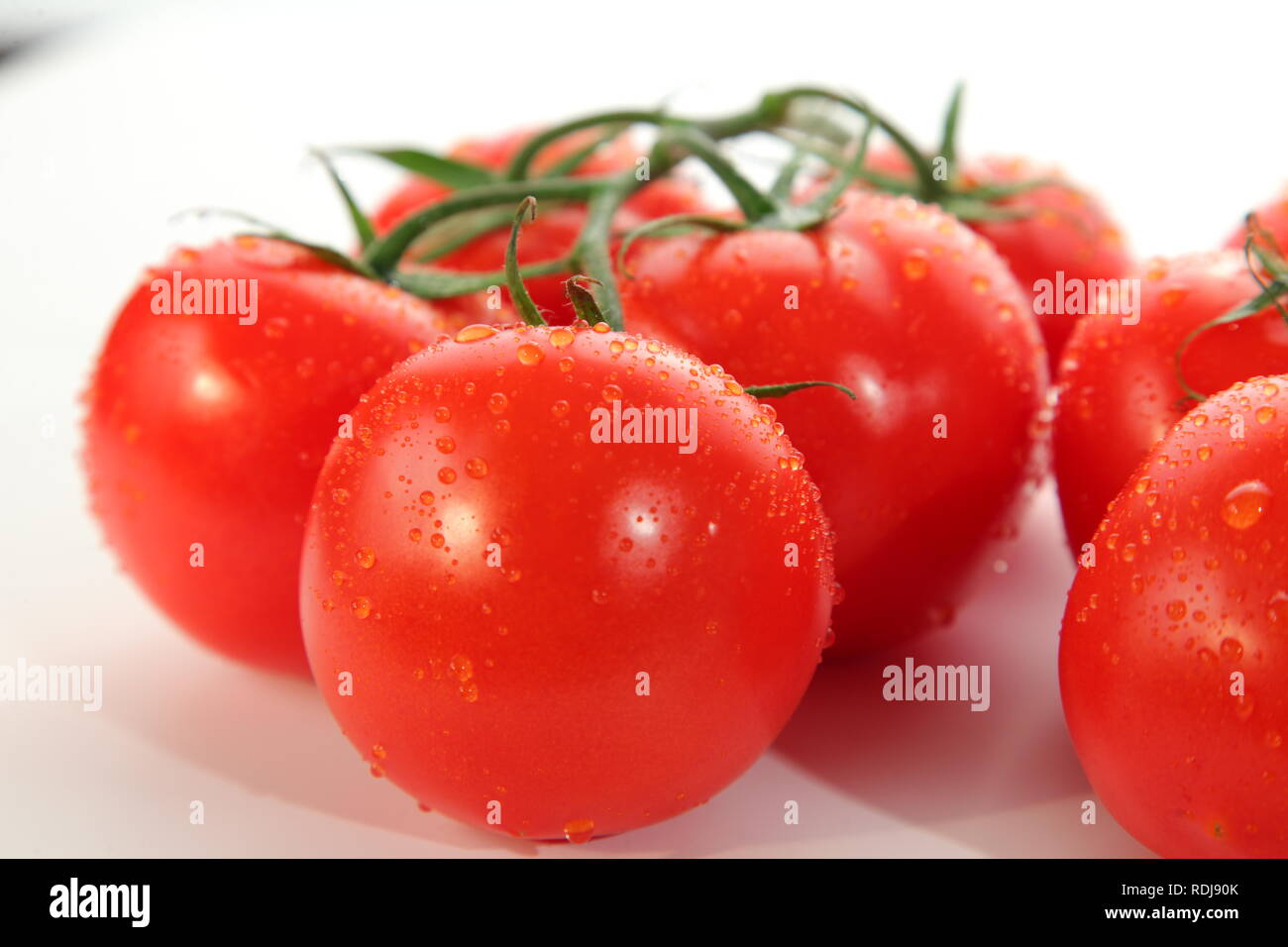 Raw shiny tomato bunch Stock Photo - Alamy