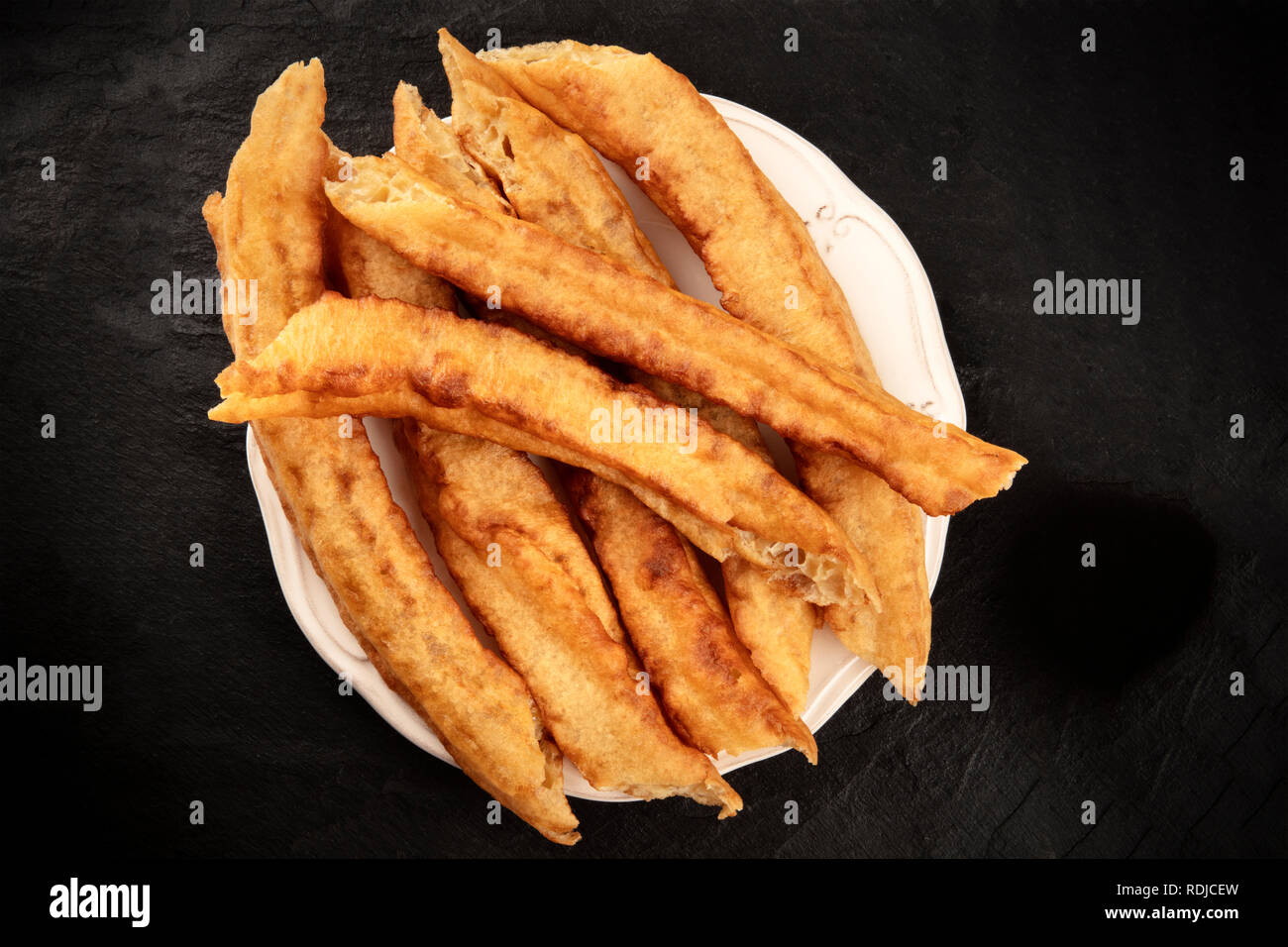 Traditional Spanish porras, a typical Madrid Sunday breakfast, shot ...