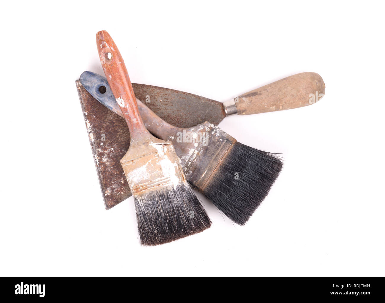 Old paintbrushes with a putty knife, isolated on a white background ...