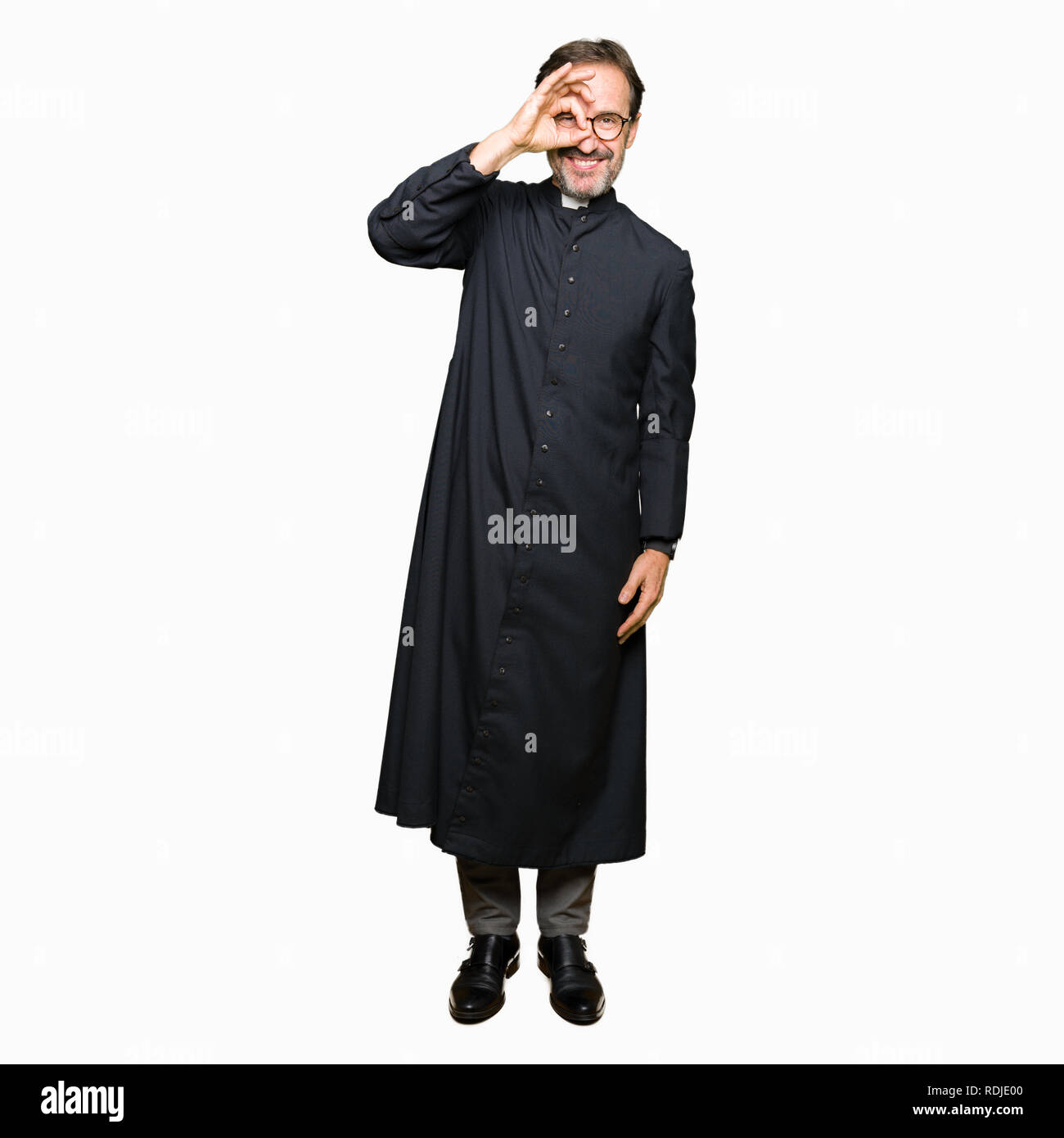 Middle age priest man wearing catholic robe doing ok gesture with hand ...