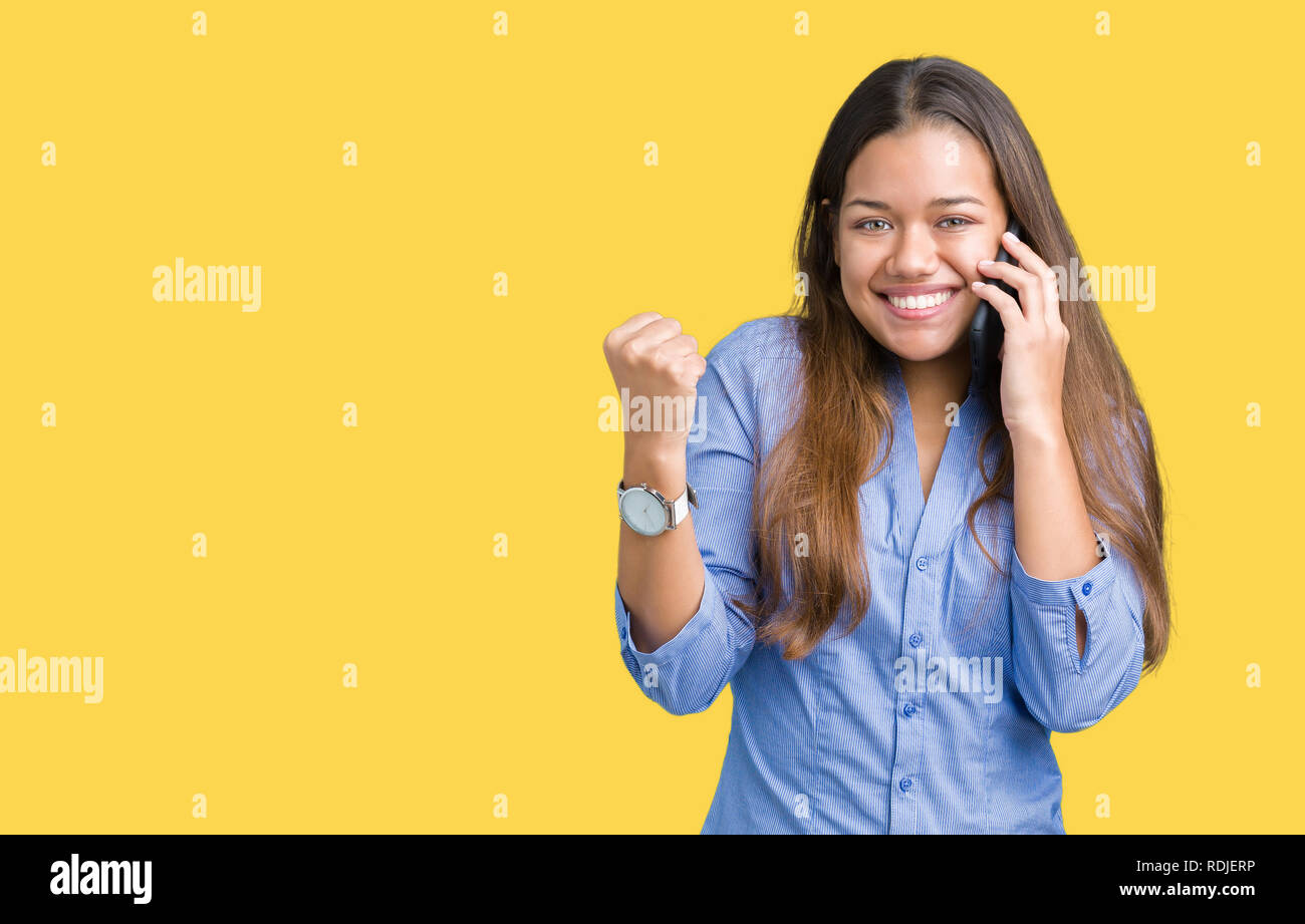 Young beautiful brunette business woman talking on smartphone over ...