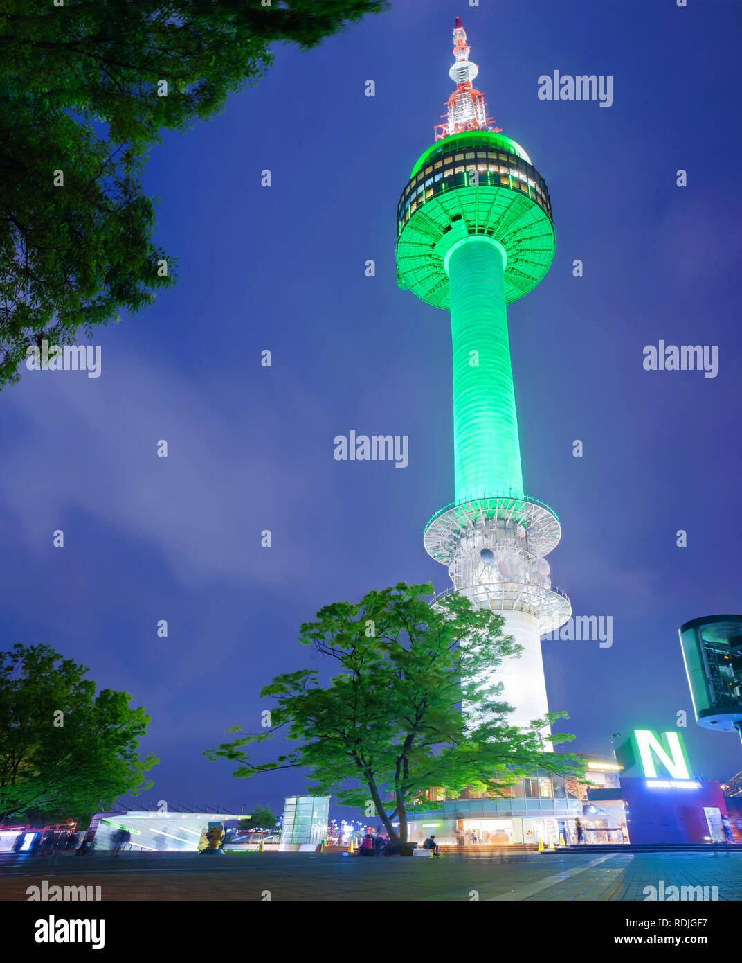 Seoul Tower or Namsan Tower with red maple leaves foreground and ...