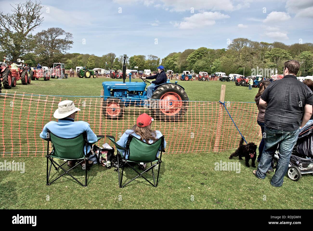 Spectators watch a vintage blue tractor parade at the Anglesey Vintage ...