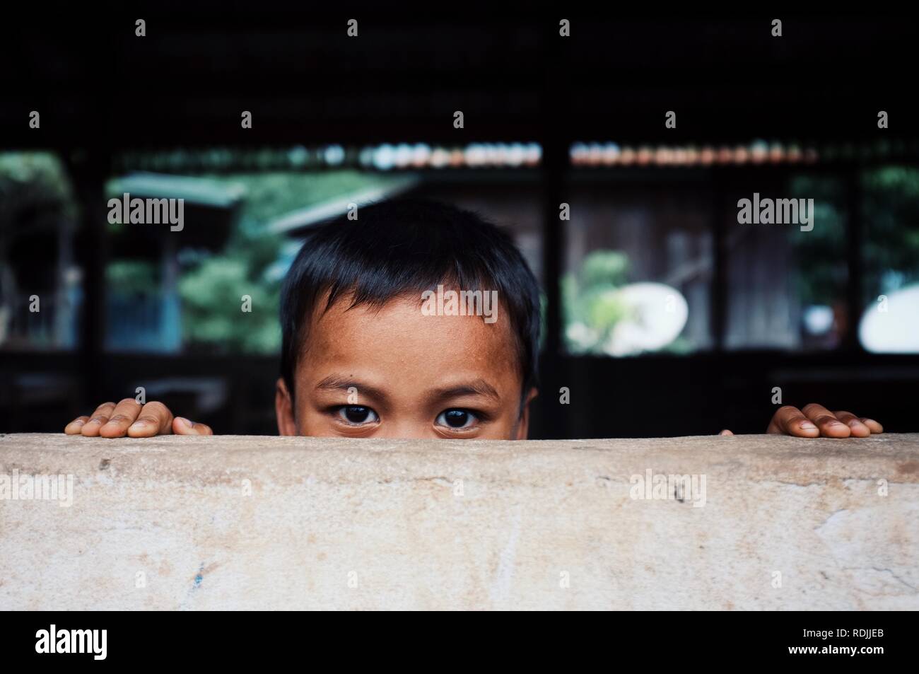 Boy and girl hiding behind hands hi-res stock photography and images ...