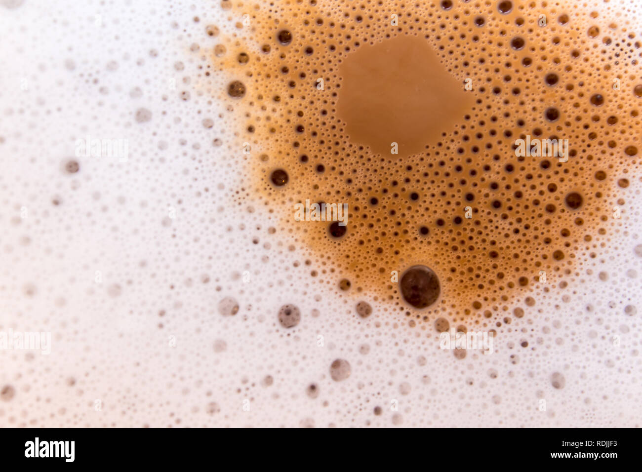 Surface texture of hot milk coffee and soft froth, close up food ...