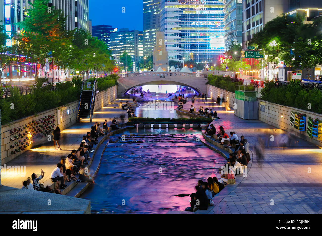 Colorful city lights of Cheonggyecheon Stream Park with Crowd at night ...