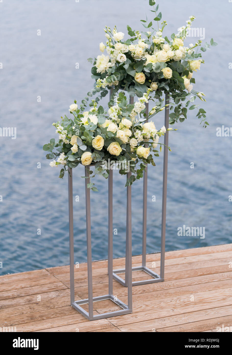 modern stands with flowers on the background of the sea for the wedding ...