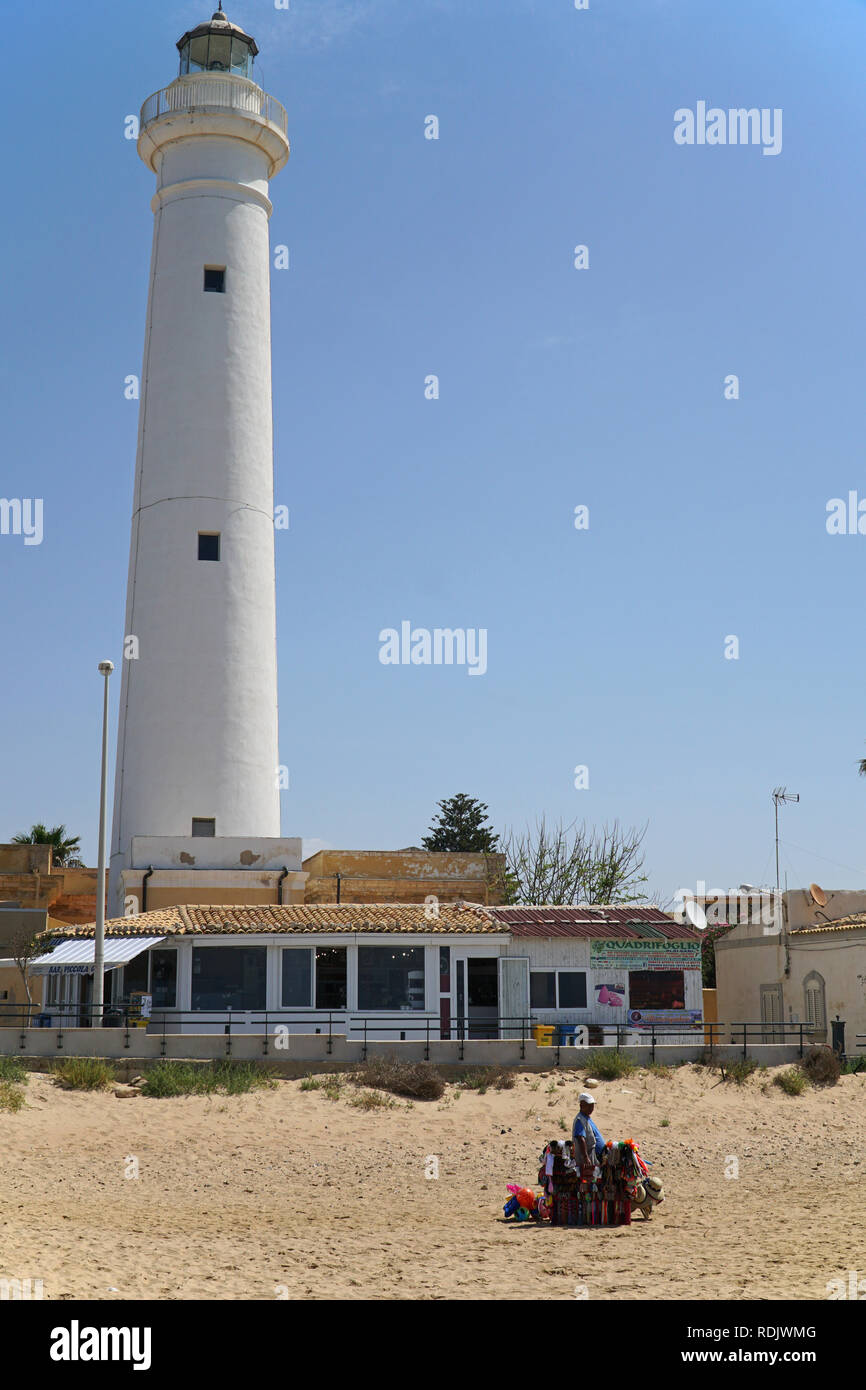 Lighthouse at Punta Secca or Faro Di Punta Secca with a beach vendor ...