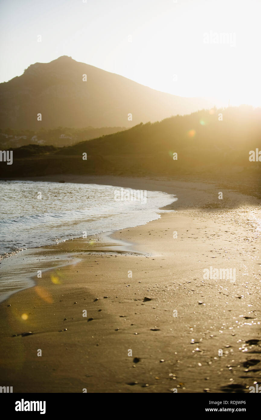Sandy beach at dusk Stock Photo - Alamy