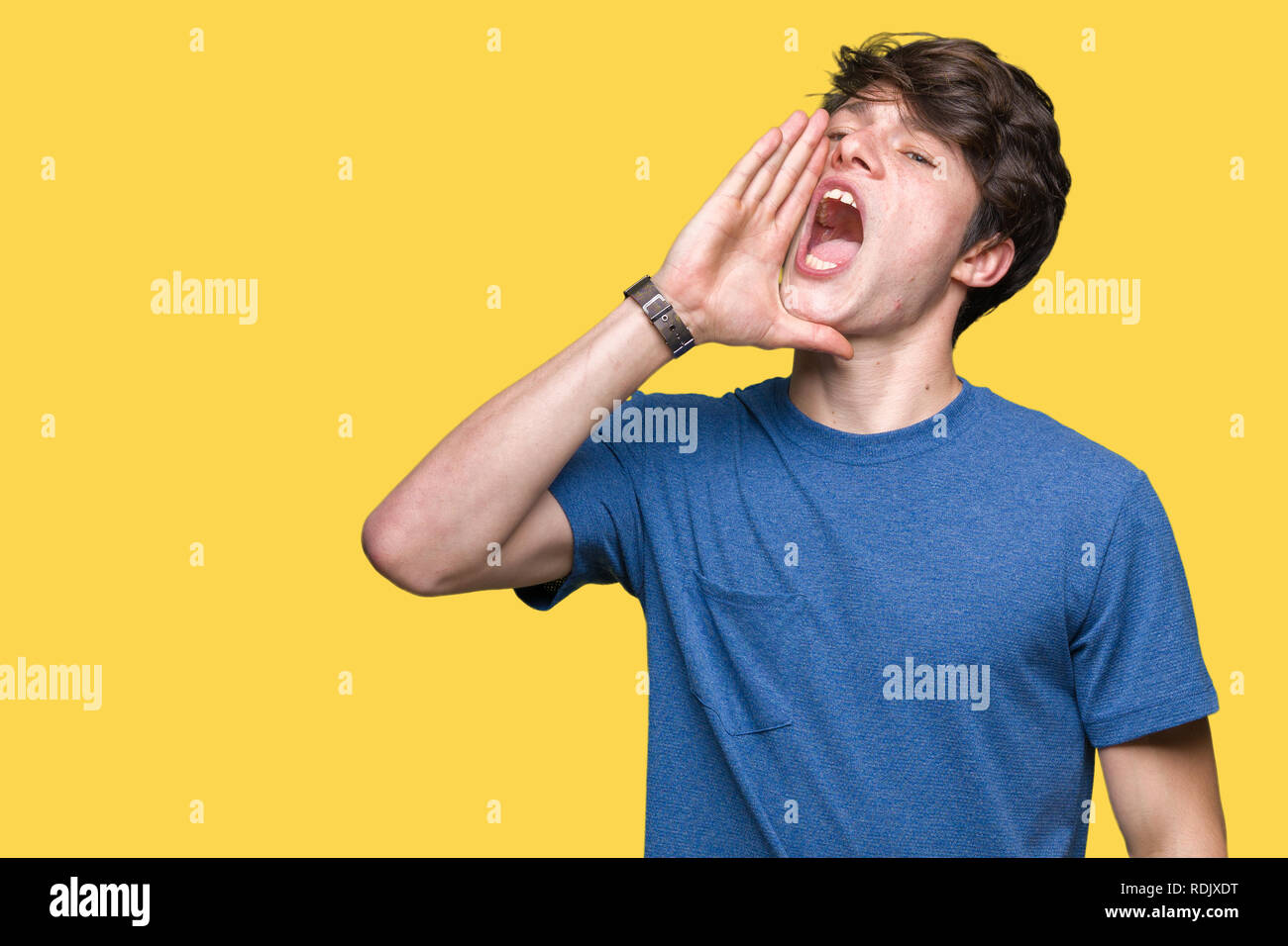Young handsome man wearing blue t-shirt over isolated background ...