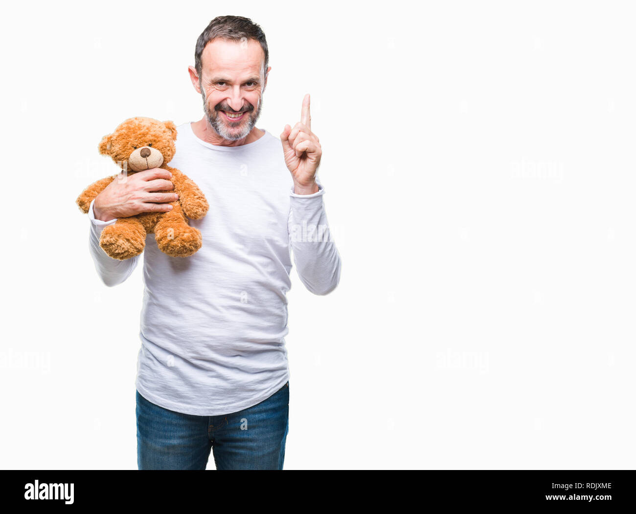 Middle age senior hoary man holding teddy bear over isolated background ...