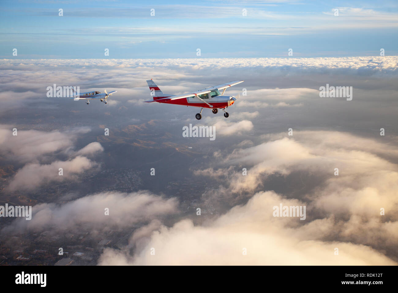 Popular single-engine airplane flying through the clouds Stock Photo ...