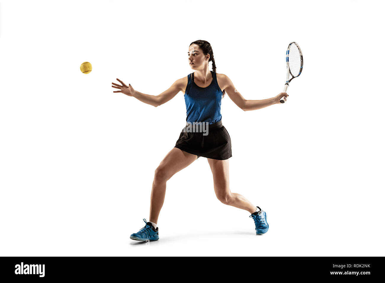 Full length portrait of young woman playing tennis isolated on white ...