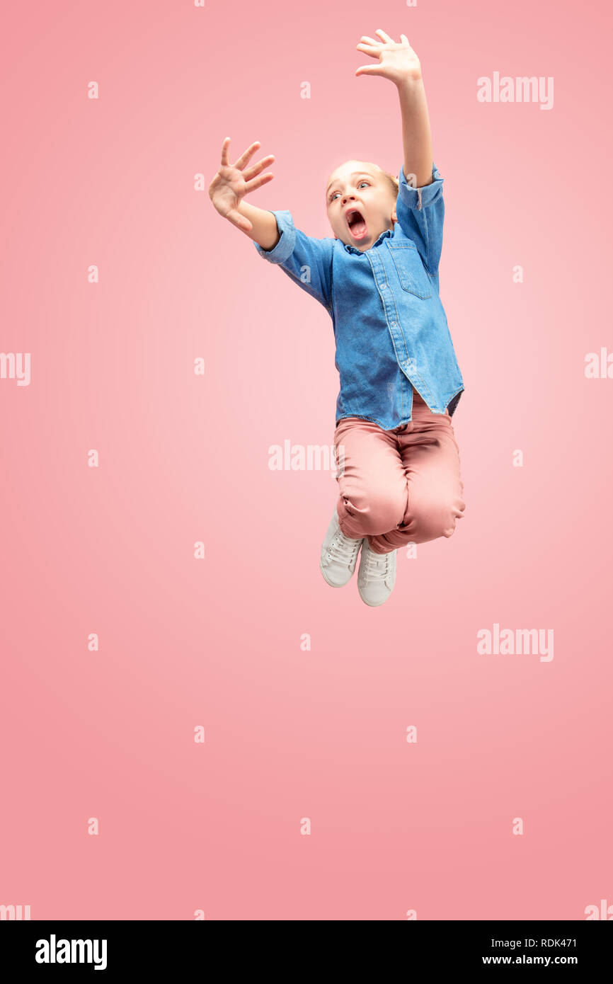 Young scared surprised caucasian teen girl jumping in the air, isolated ...