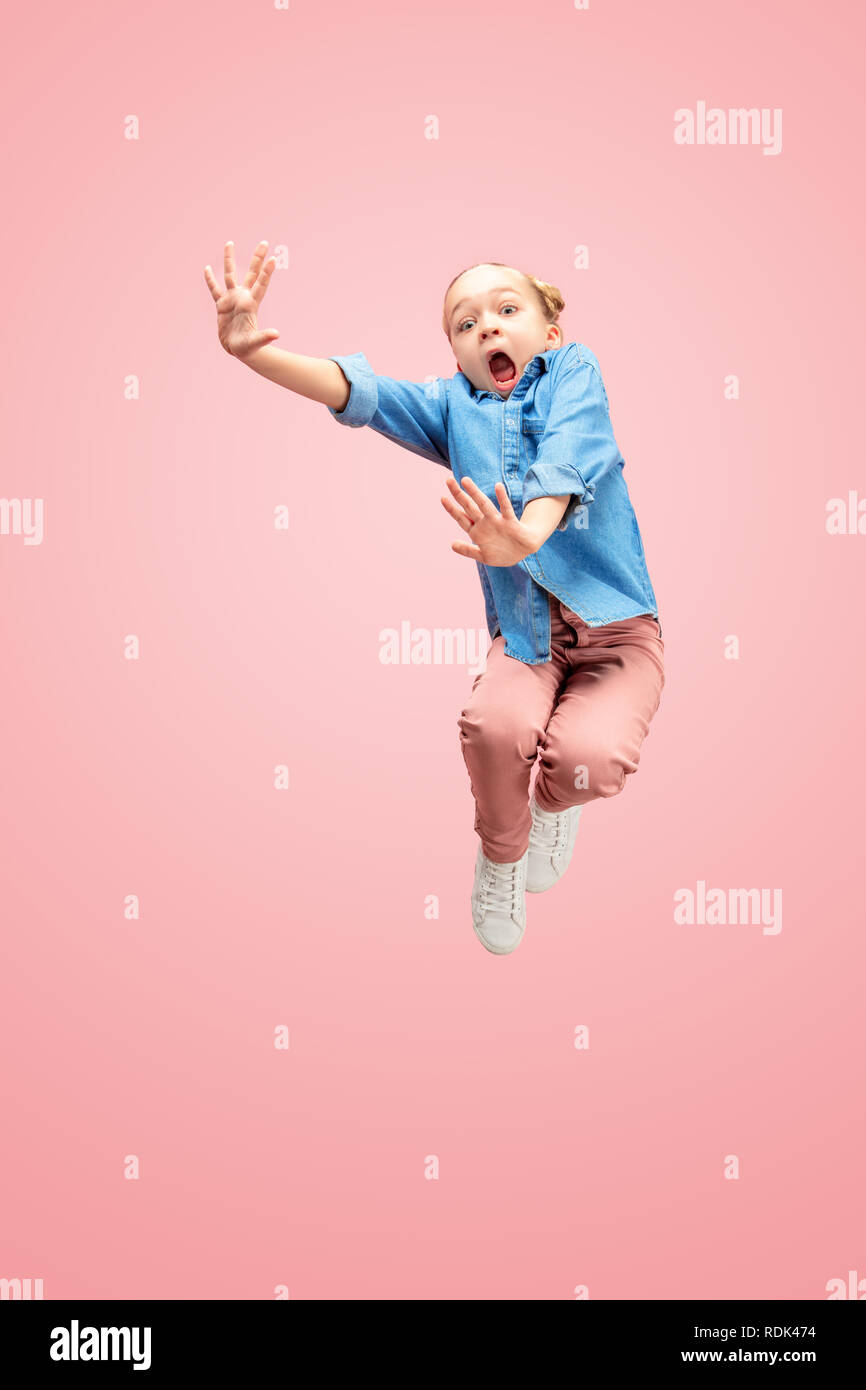 Young scared surprised caucasian teen girl jumping in the air, isolated ...