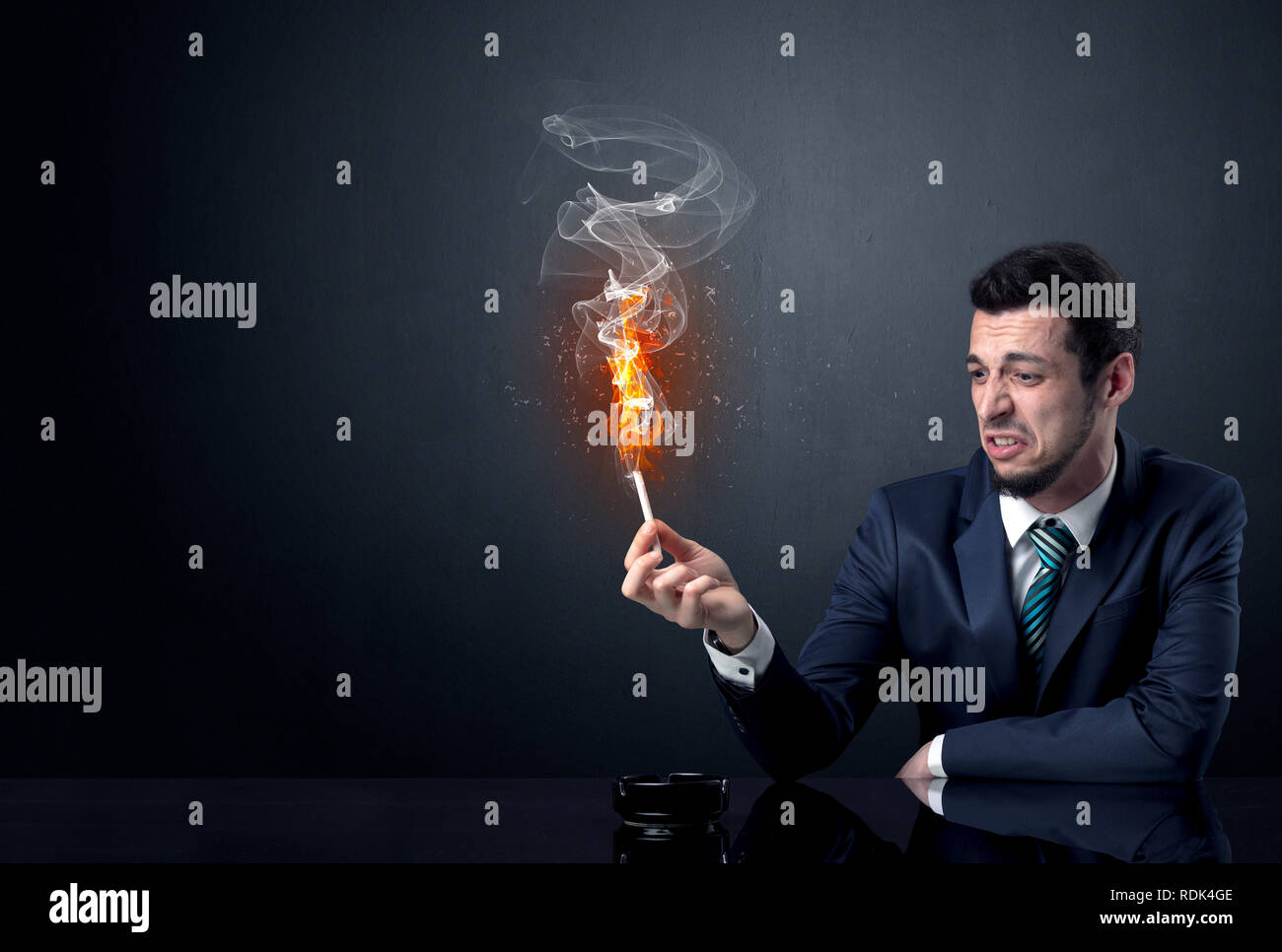 Businessman smoking with inferno effect Stock Photo - Alamy
