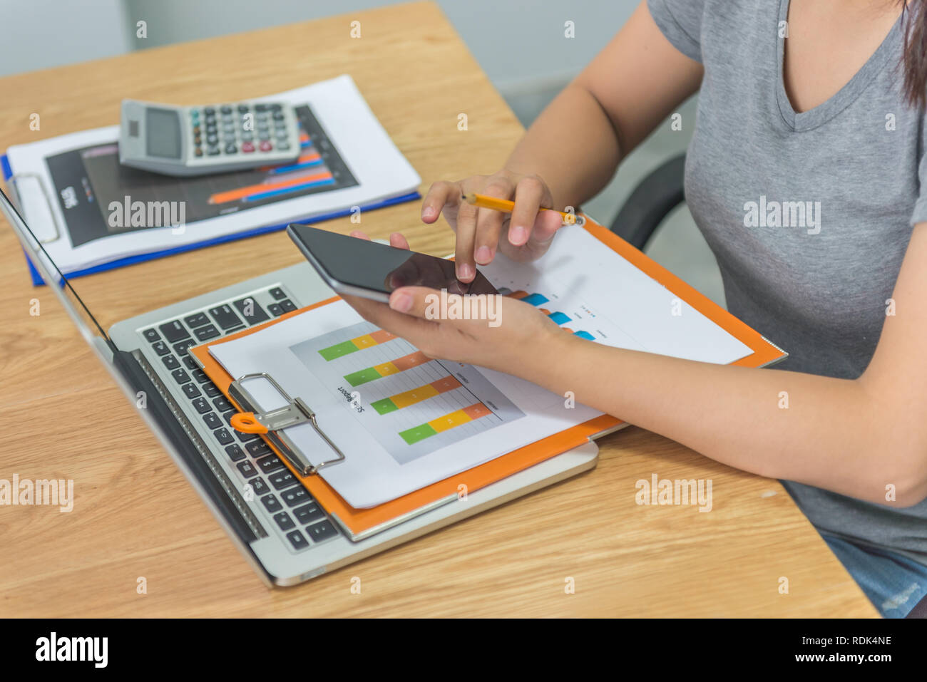 Woman finger tapping on smartphone screen while holding pencil Stock ...