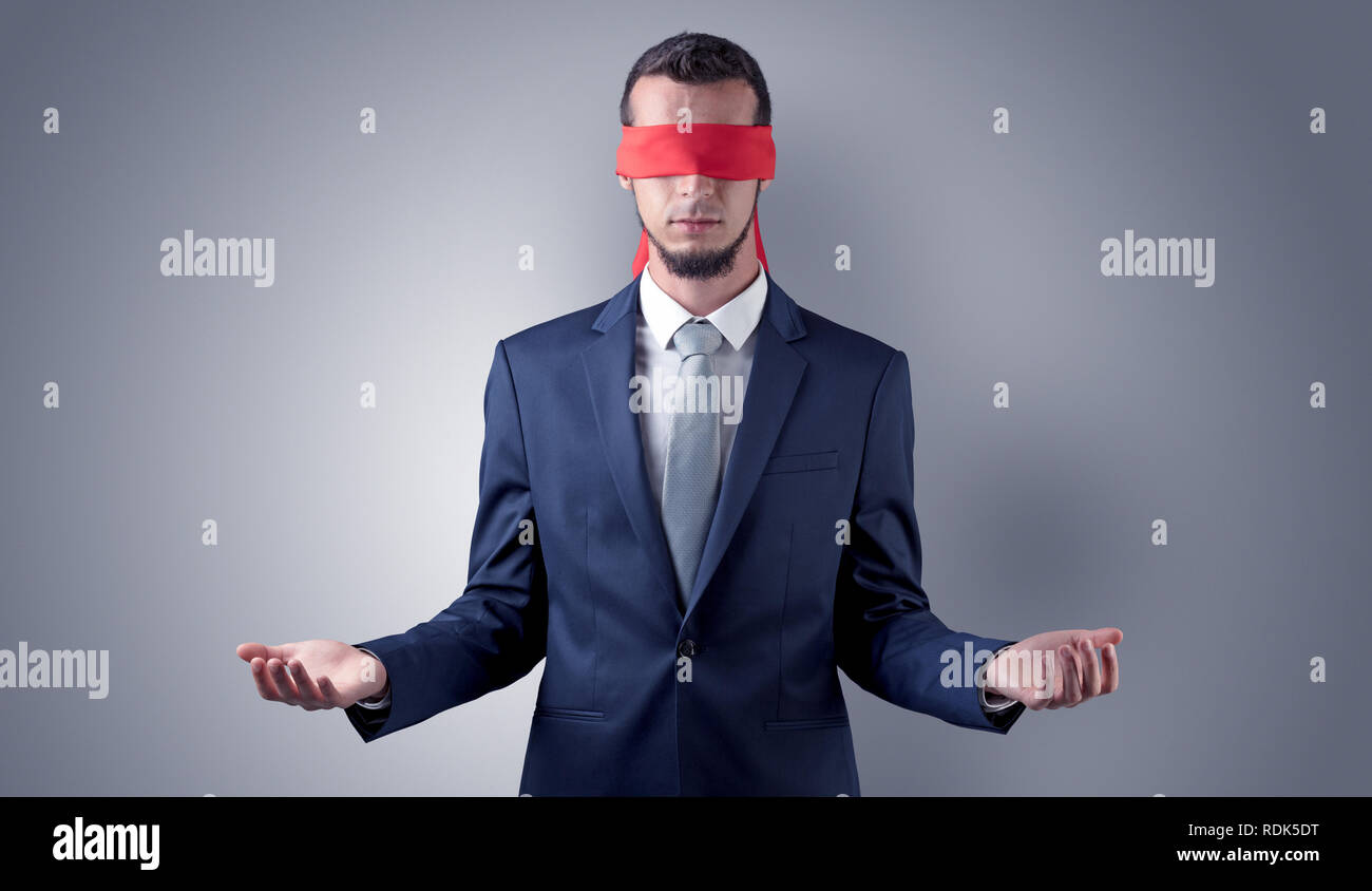 Covered eye, indecisive businessman standing blind in front of a wall ...
