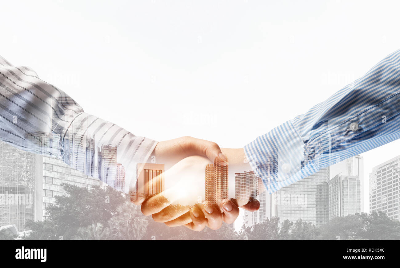 Business handshake as idea for unity and cooperation or greeting. Mixed ...