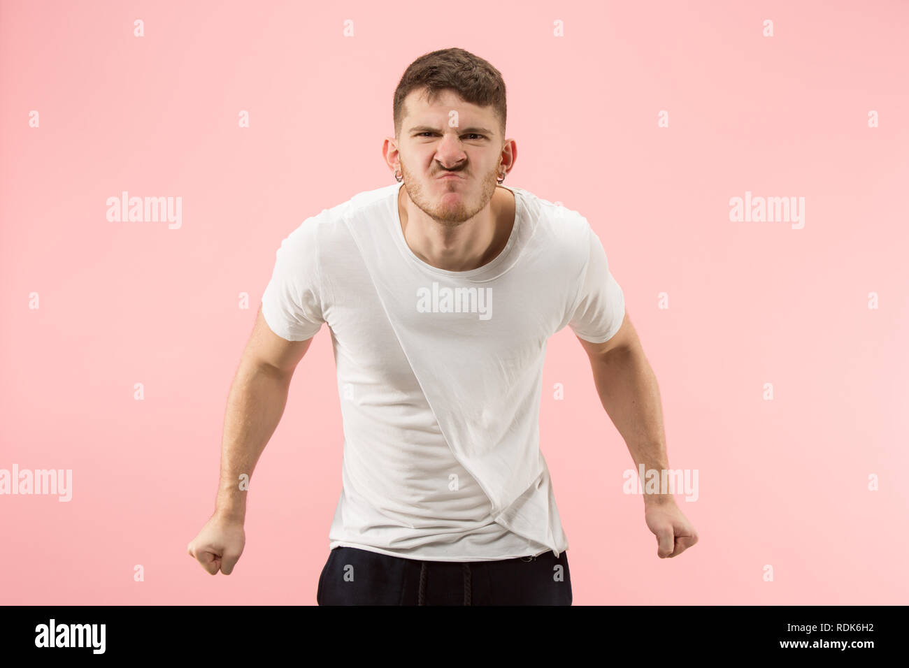 Screaming, hate, rage. Crying emotional angry man screaming on pink ...