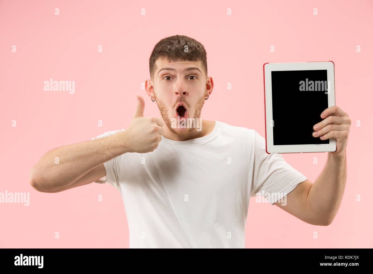 portrait of smiling man pointing at laptop with blank screen isolated ...