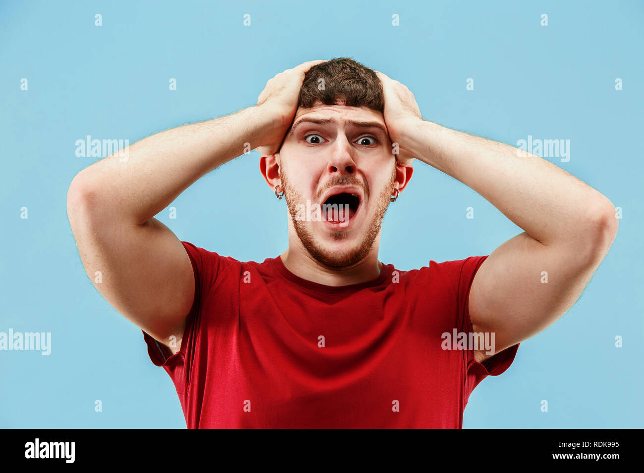 Screaming, hate, rage. Crying emotional angry man screaming on blue ...