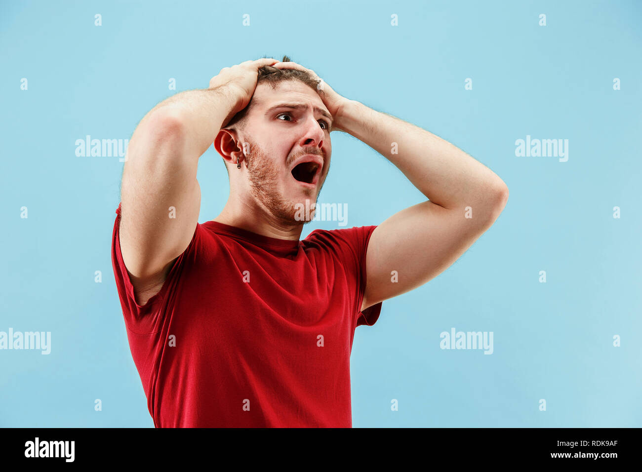 Screaming, hate, rage. Crying emotional angry man screaming on blue ...