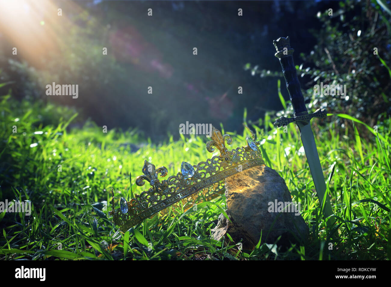 mysterious and magical photo of silver king crown and sword over the ...