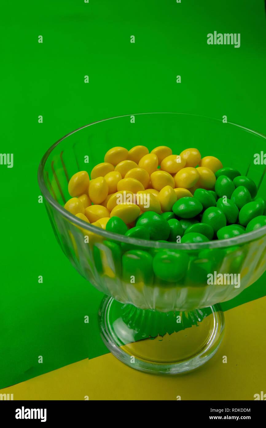 Green and Yellow sweets in a glass matching the colour of their ...