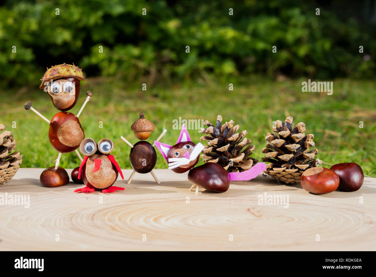Group of little characters or figurines made with chestnuts on a wooden ...