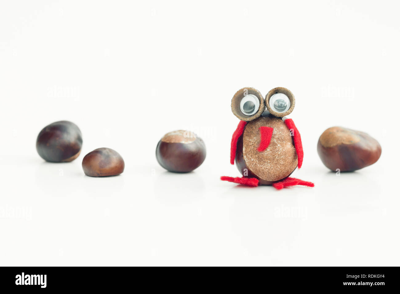 Funny owl shape character or figurine made with chestnuts in white ...
