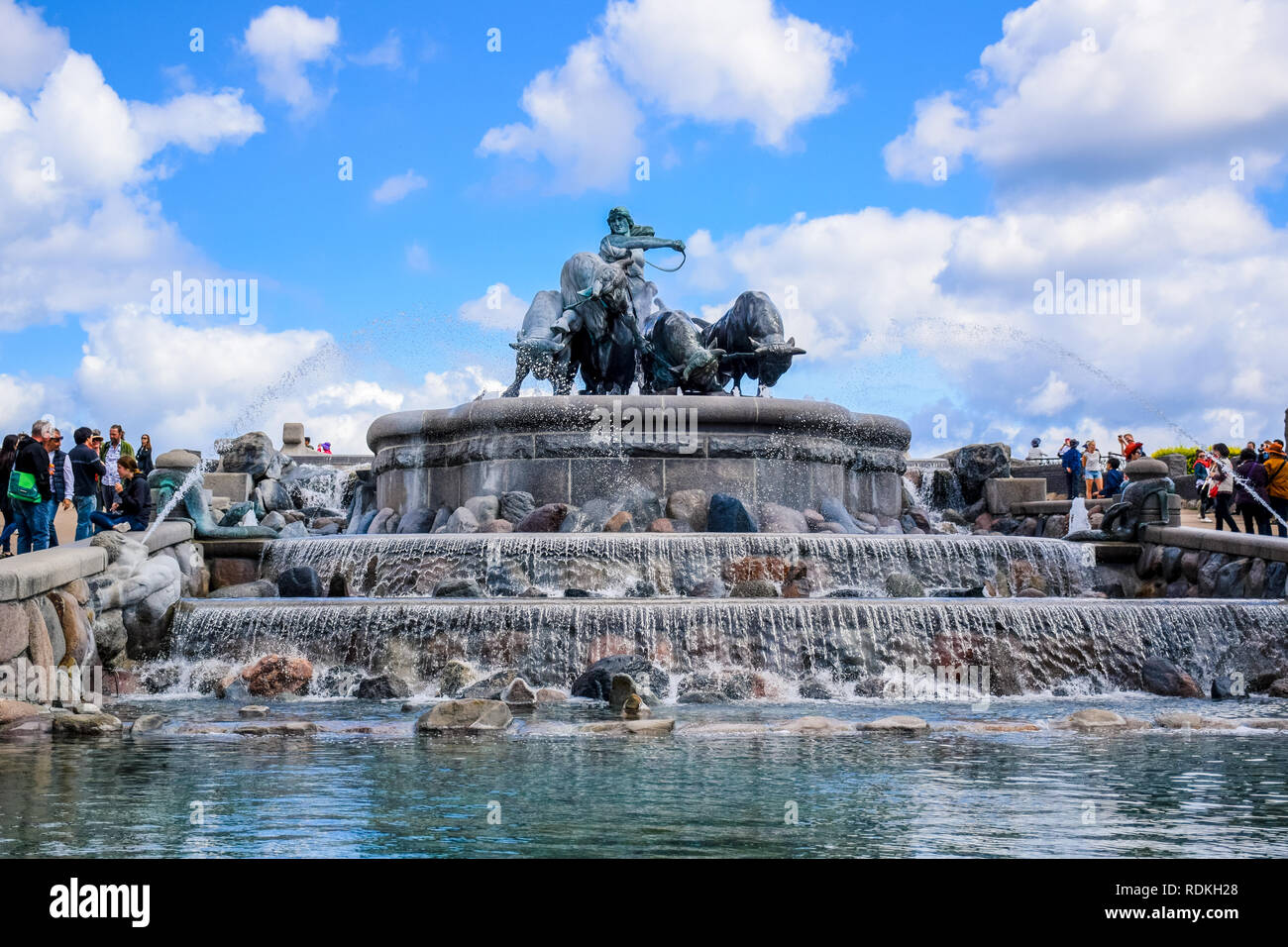 Tourists are visiting the Gefion Fountain, a large-scale group of ...