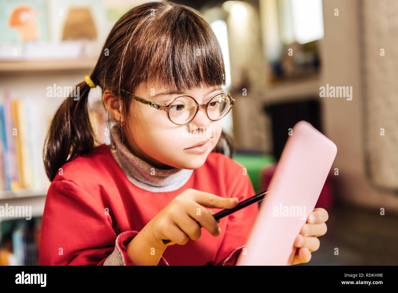 Beautiful girl with genetic disorder feeling involved in drawing Stock ...
